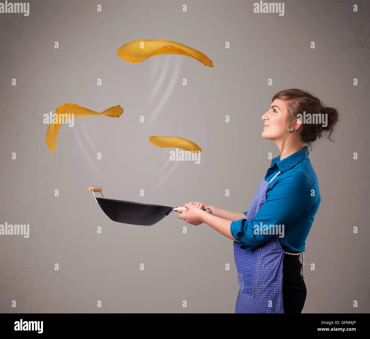 Woman making pancakes Stock Photo - Alamy