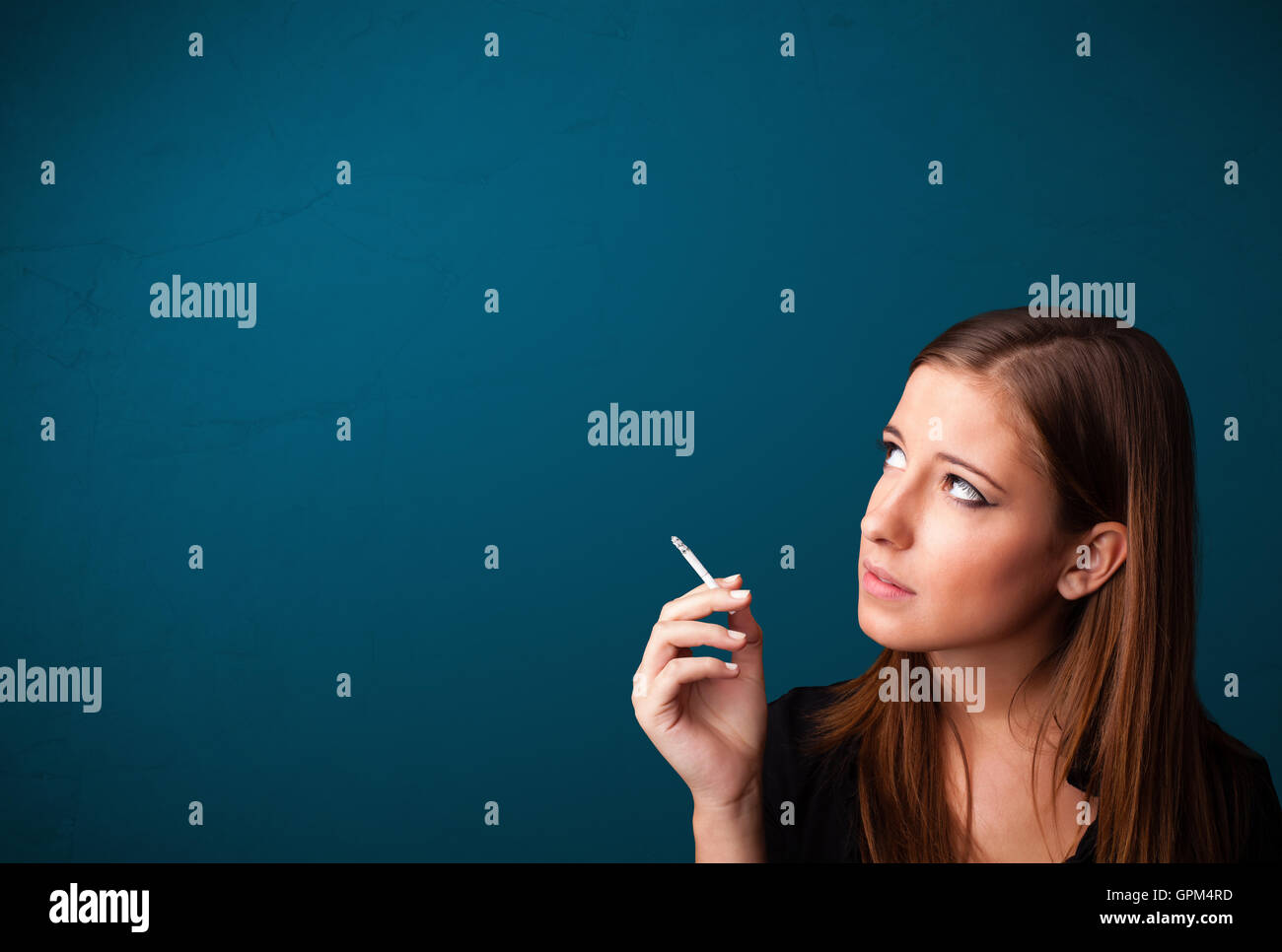 Beautiful woman smoking cigarette vith hi-res stock photography and ...