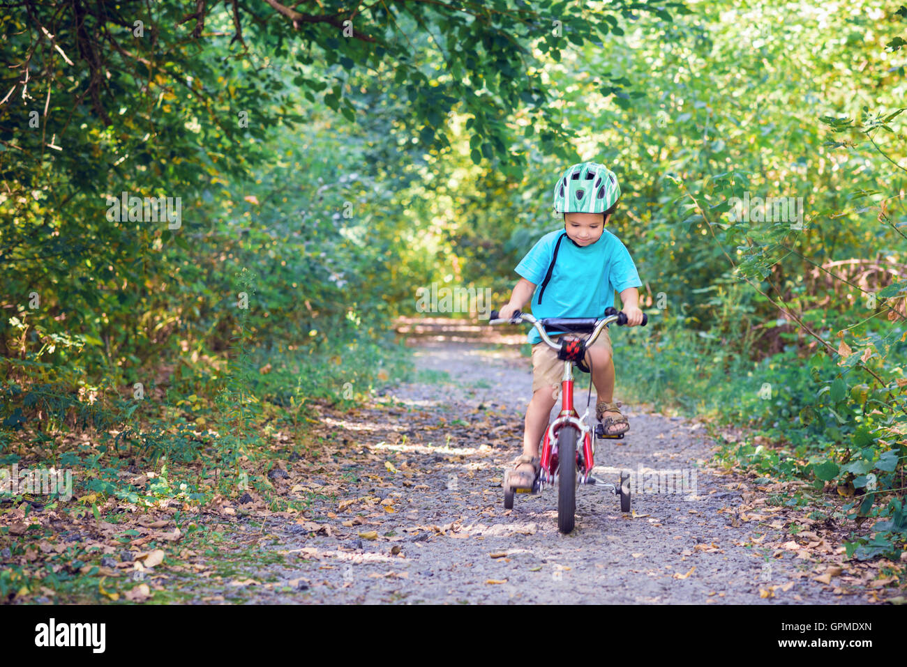 Child riding a bicycle Stock Photo - Alamy