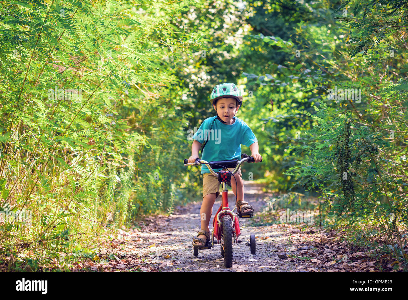 Child riding a bicycle Stock Photo - Alamy