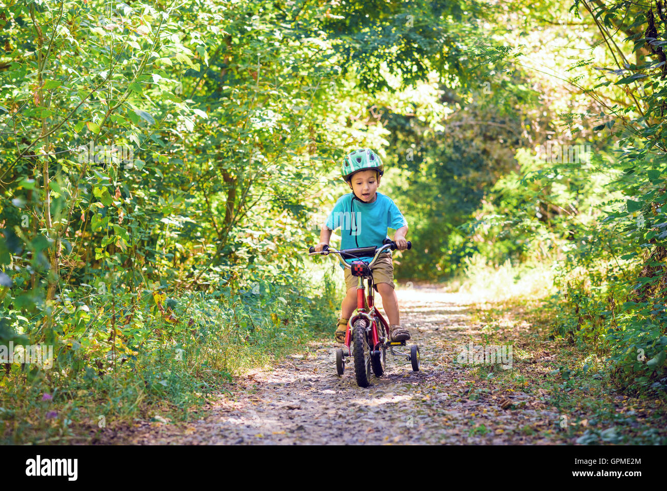 Child riding a bicycle Stock Photo - Alamy