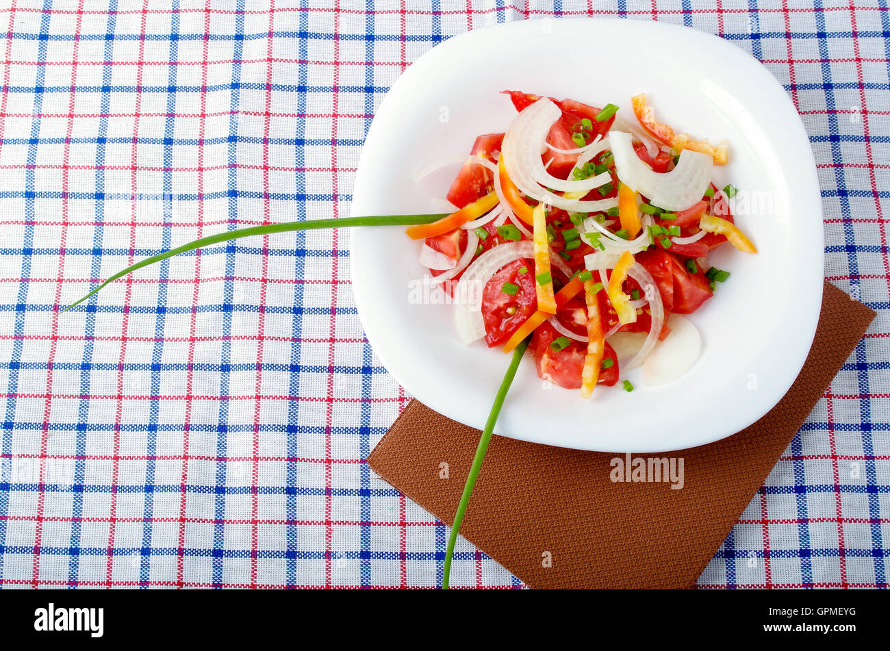 Top view of a small portion of vegetarian salad from fresh tomatoes ...