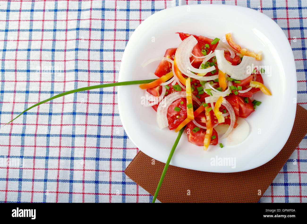 Top view of a small portion of vegetarian salad from fresh tomatoes ...