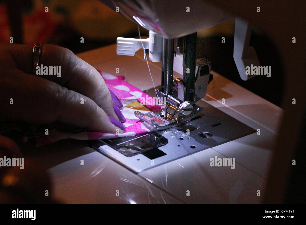Sewing with modern computerized machine showing needle threader Stock ...