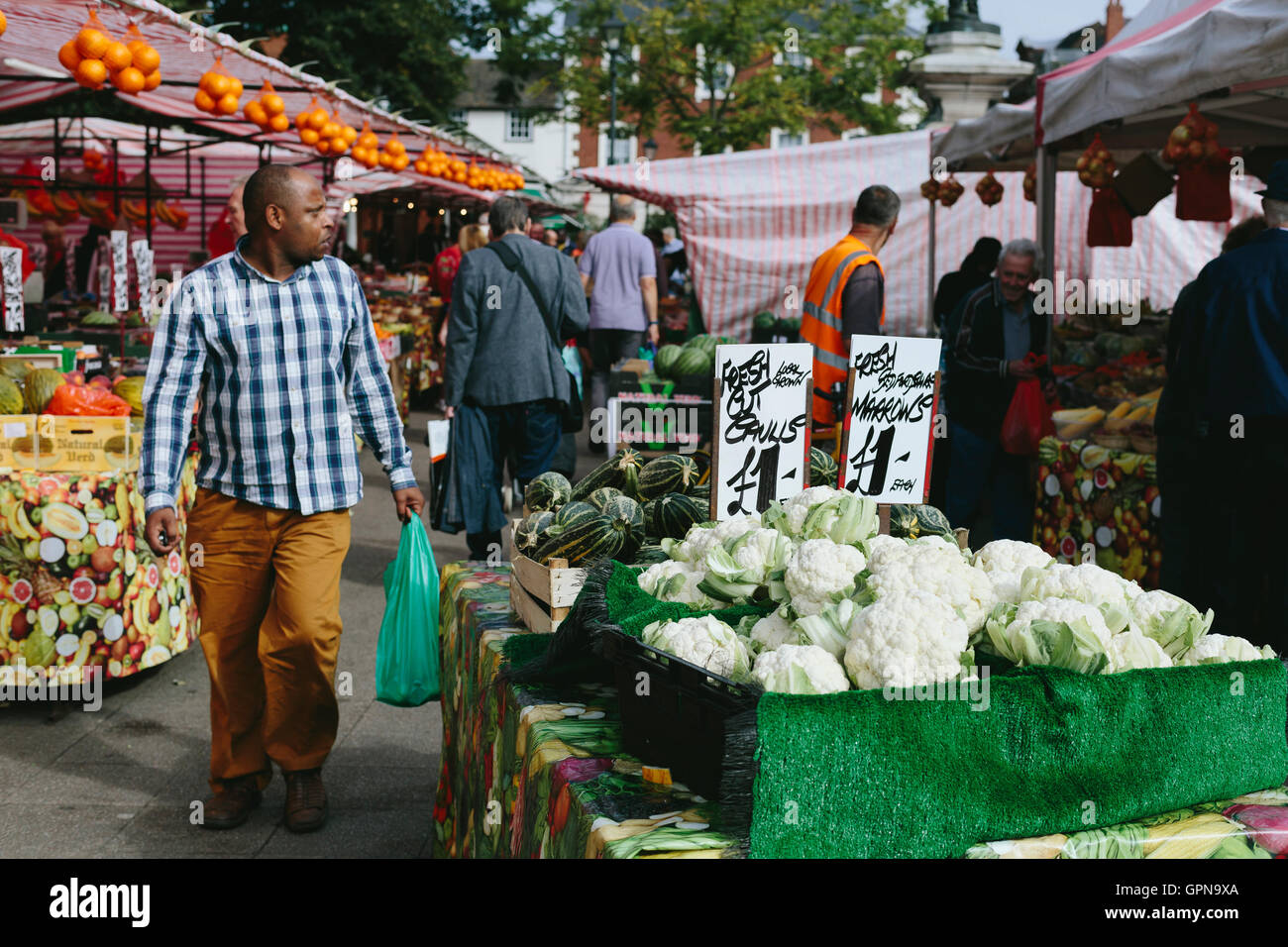 Bedford street market, man walking through market Stock Photo - Alamy