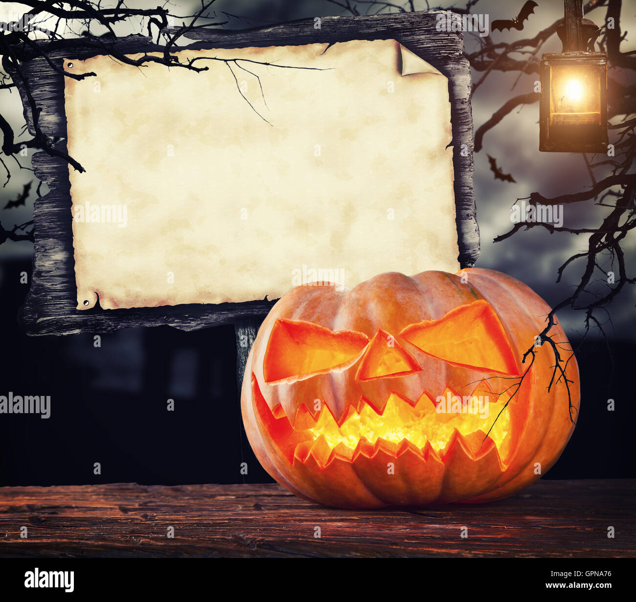 Scary halloween pumpkin with empty wooden sign board for copyspace ...