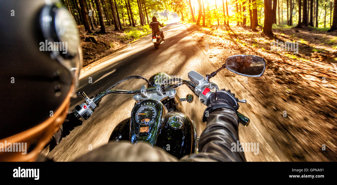 Motorcycle drivers riding on motorway in beautiful sunset light. Shot ...