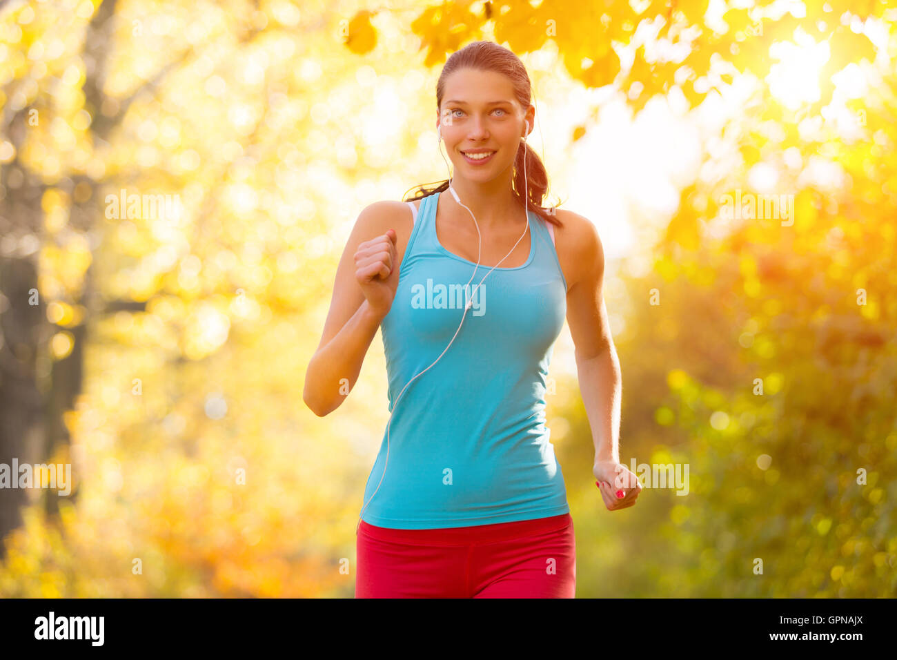 Athlete young woman running in morning sunrise training for marathon ...