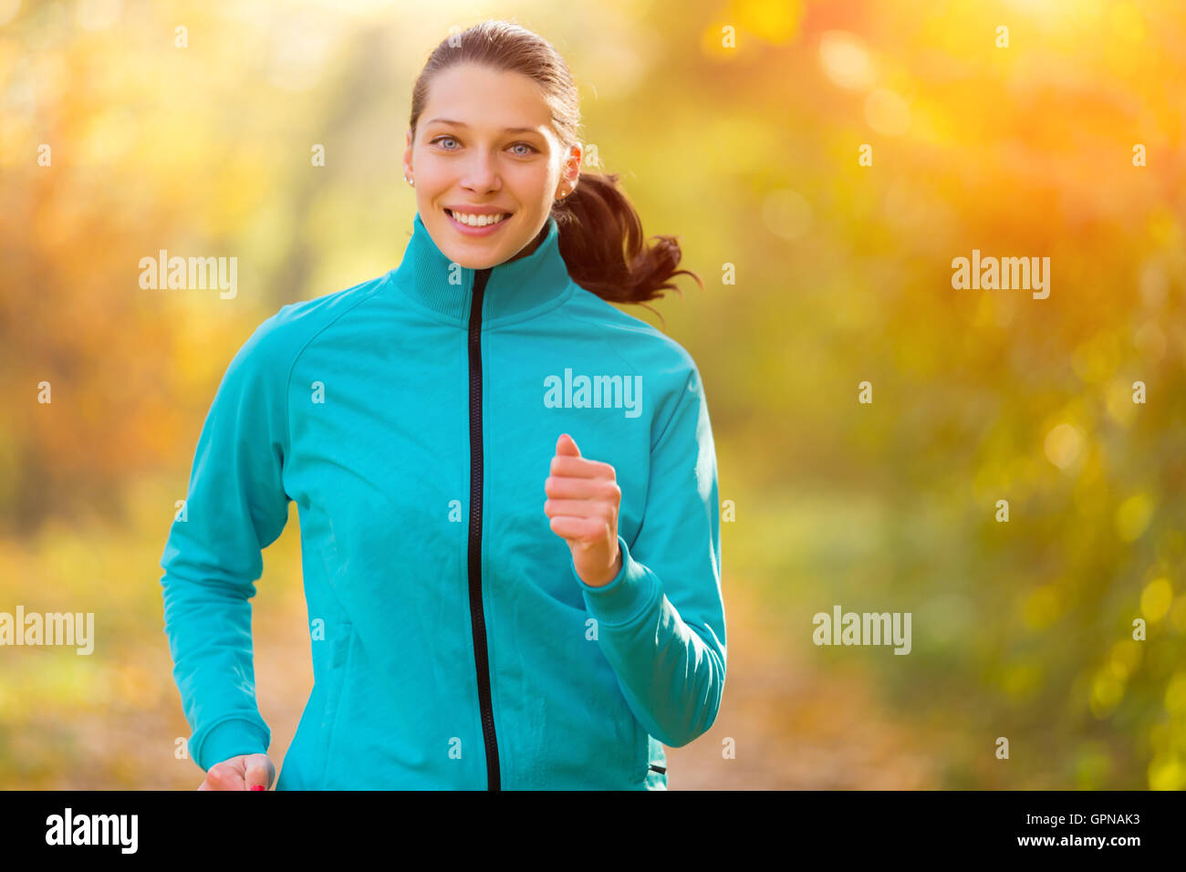 Athlete young woman running in morning sunrise training for marathon ...