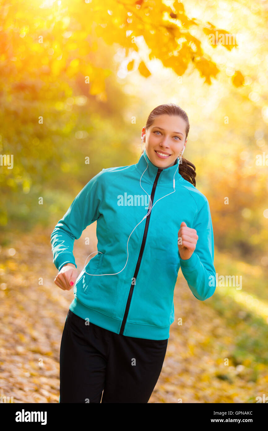 Athlete young woman running in morning sunrise training for marathon ...