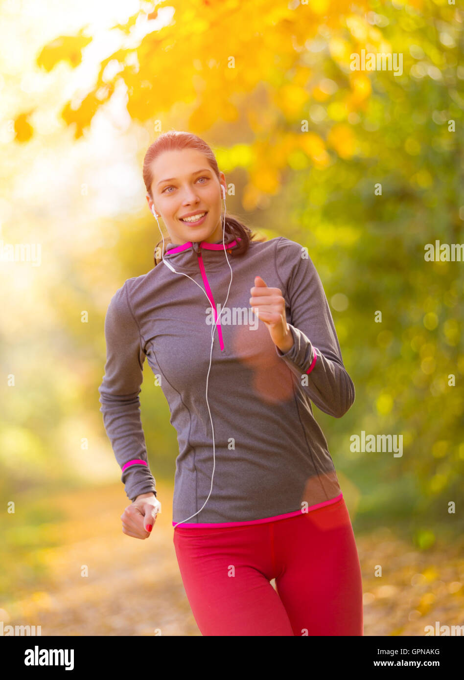 Athlete young woman running in morning sunrise training for marathon ...