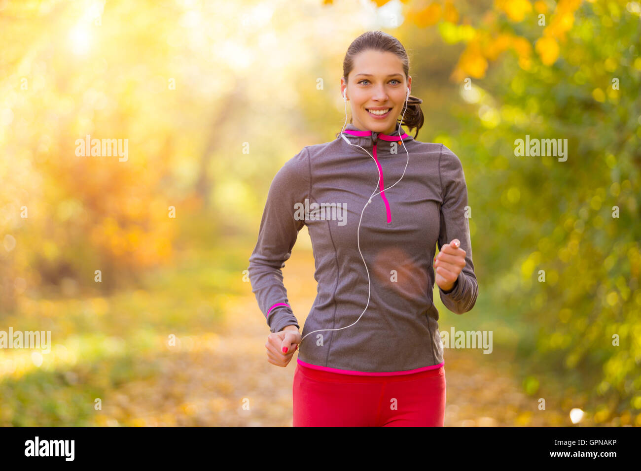 Athlete young woman running in morning sunrise training for marathon ...