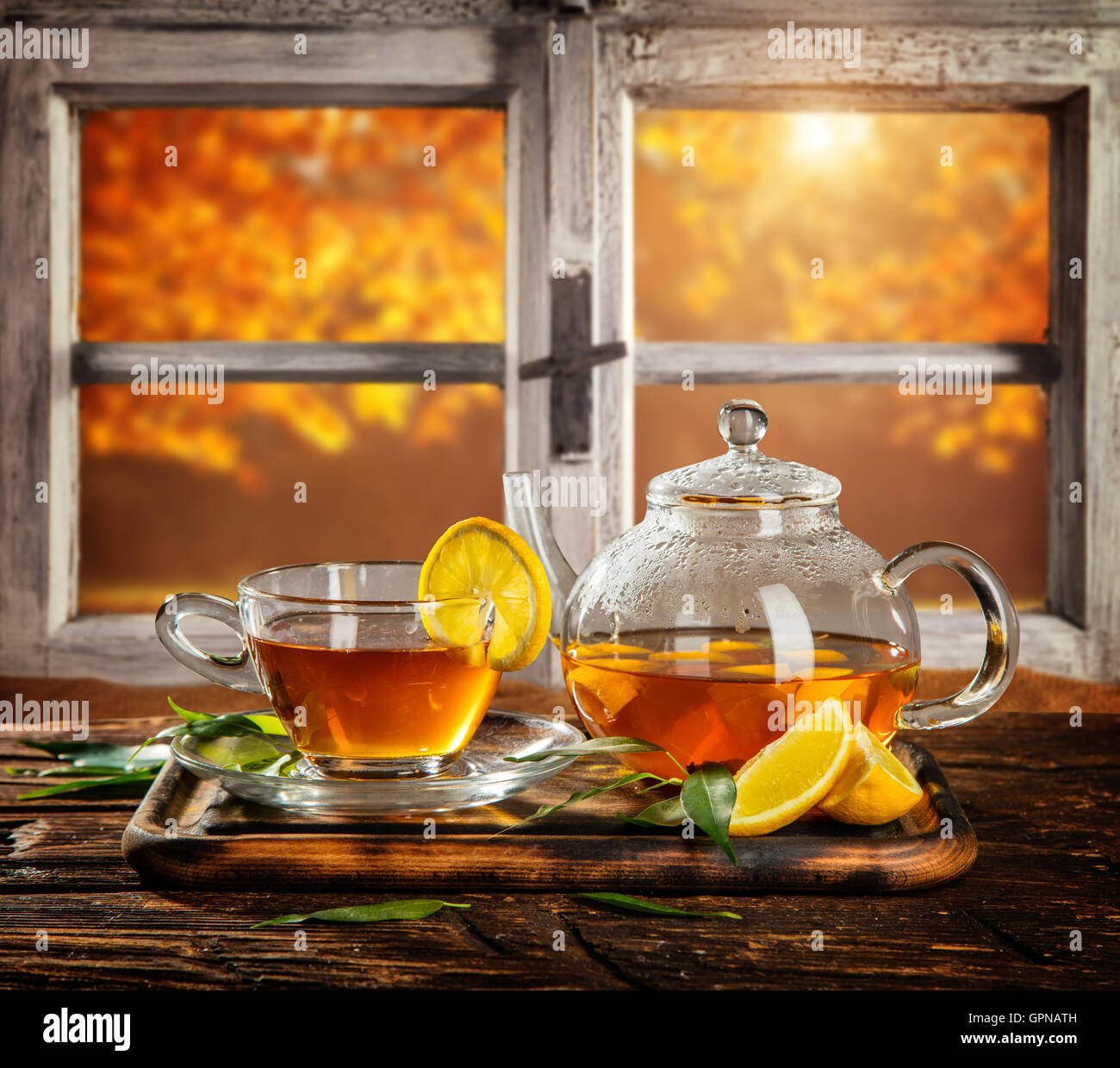 Autumn still life with tea cup on wooden planks, placed in front of ...