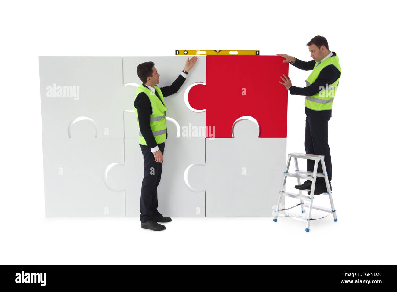 Workers assembling puzzle isolated on white background Stock Photo - Alamy