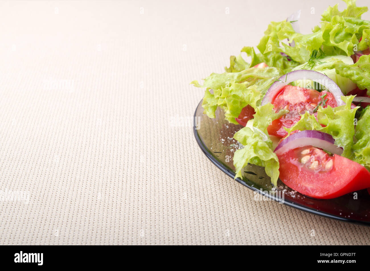 Side view of a plate of vegetable salad with fresh tomatoes, onion and ...