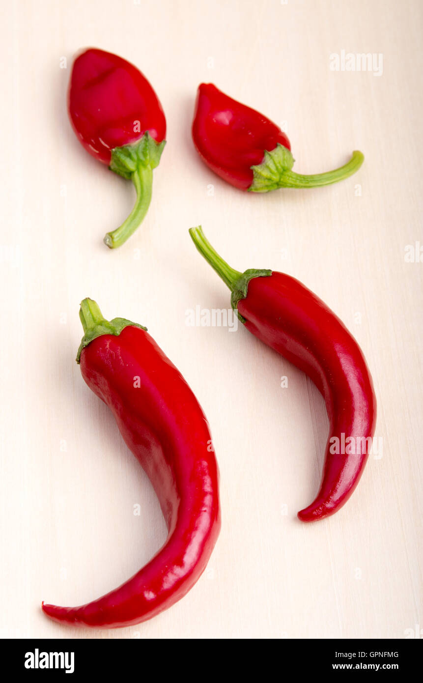 Top view of hot chili peppers on a light wooden board closeup Stock ...