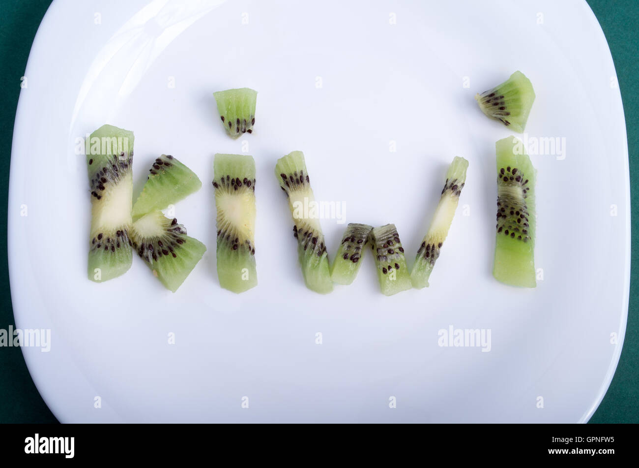 Top view of the word kiwi, letters made up of pieces of kiwi fruit on ...