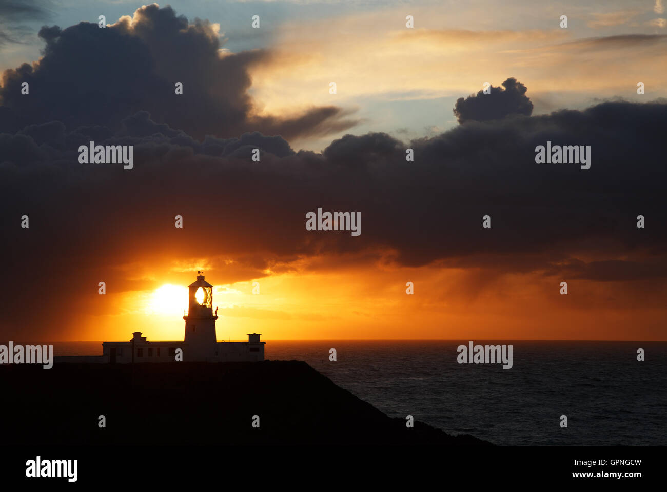 Lighthouse at Strumble Head at sunset, Pembrokeshire, Wales Stock Photo ...