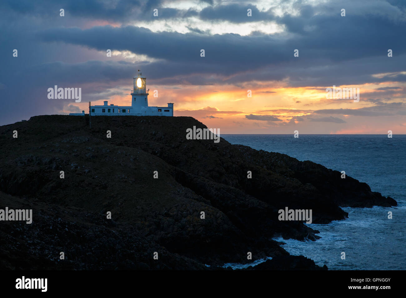 Lighthouse at Strumble Head at sunset, Pembrokeshire, Wales Stock Photo ...