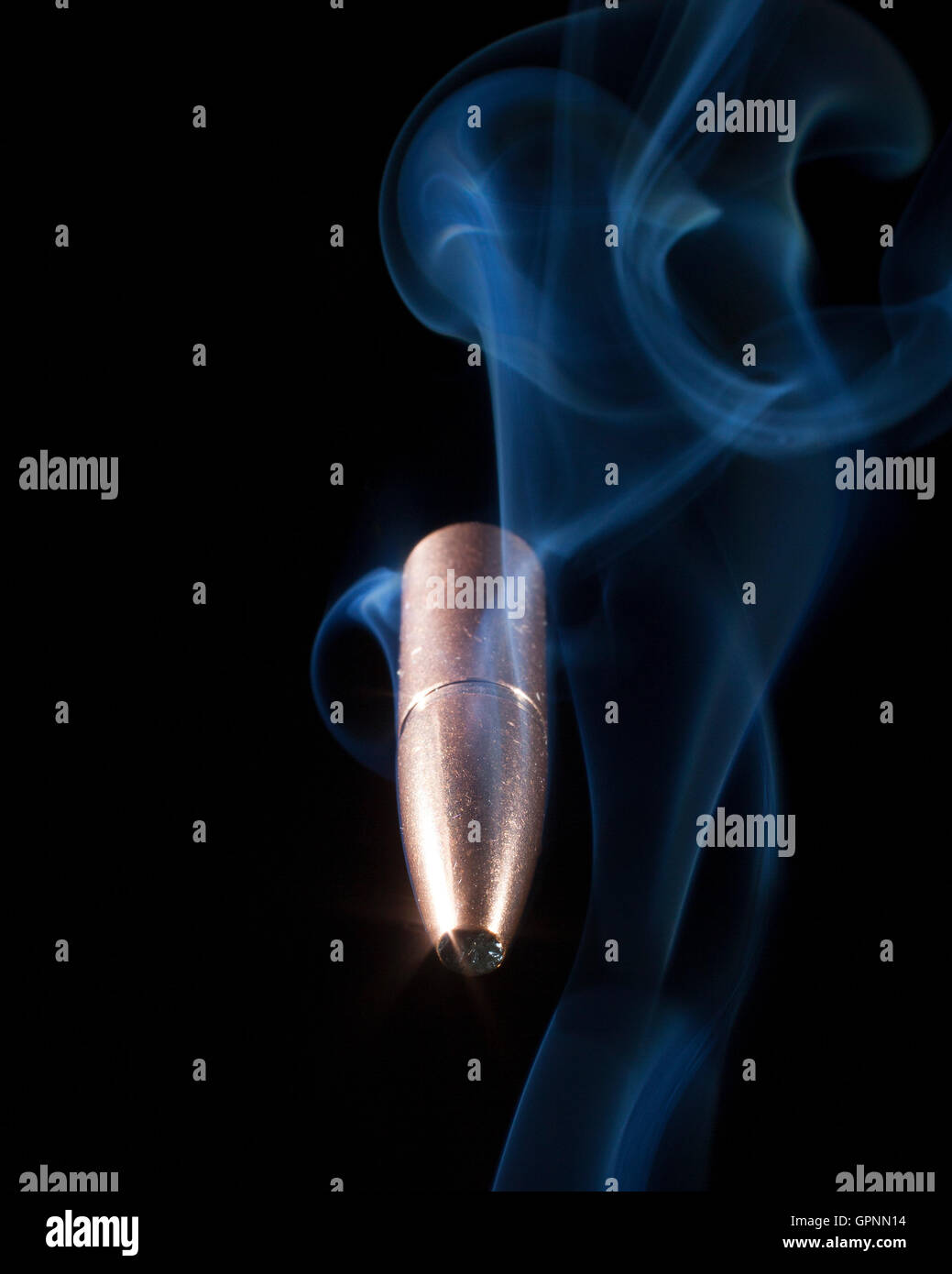 Thirty caliber bullet with smoke behind with a black background Stock ...