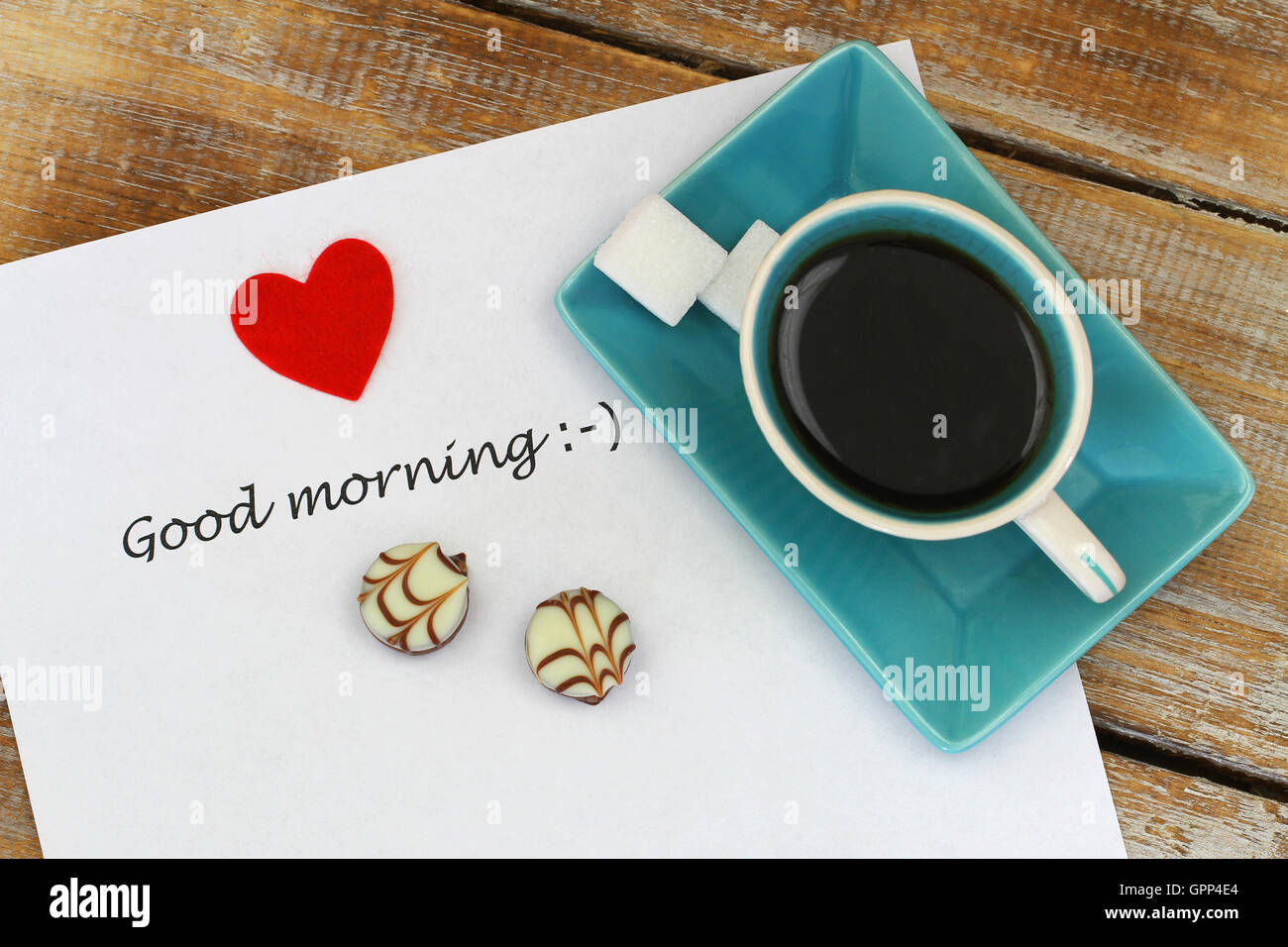 Good morning written on white paper with red hearts and two white ...