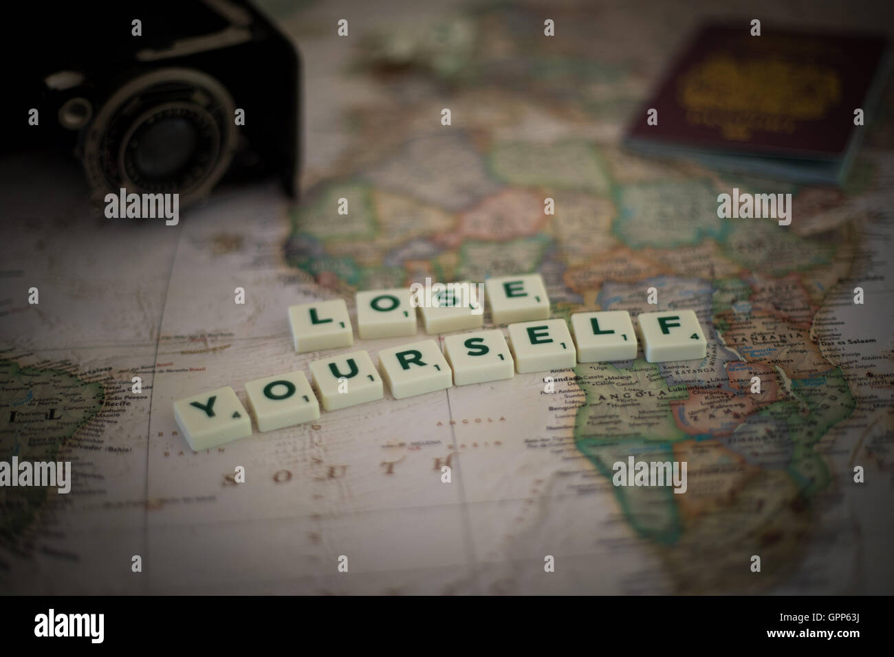 World map with quote in lettered tiles Stock Photo - Alamy