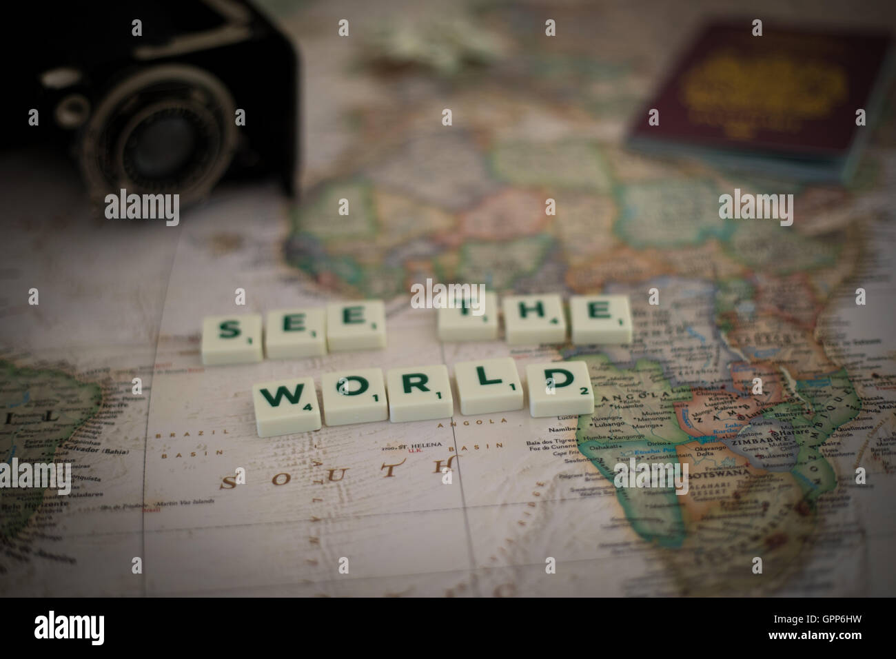 World map with quote in lettered tiles Stock Photo - Alamy