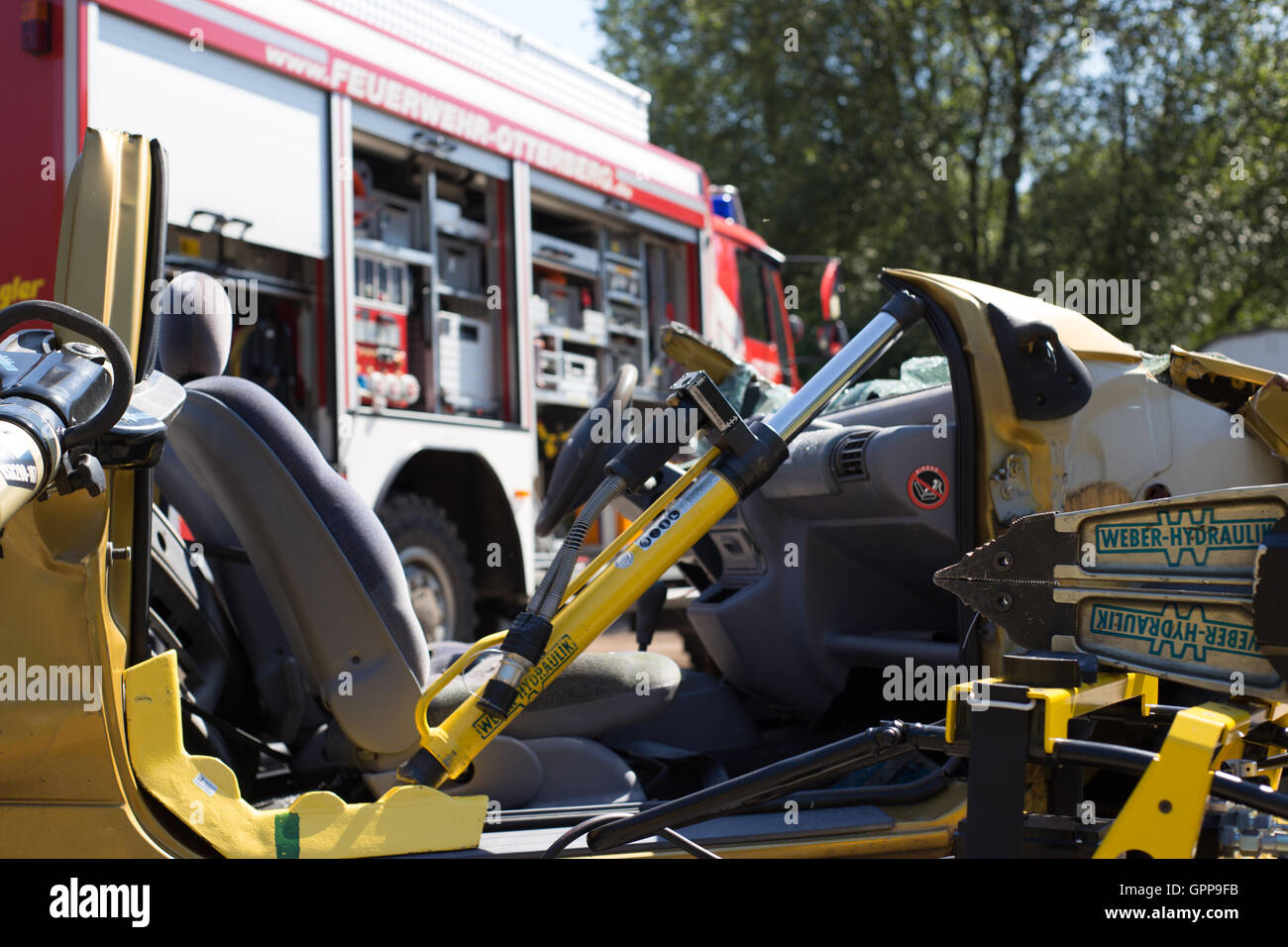 Car wrack with fire fighters scissors and spreader Stock Photo - Alamy
