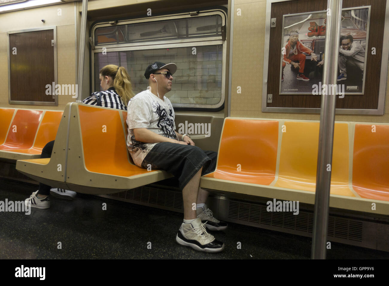 People riding a New York City subway train at an off hour when they are ...