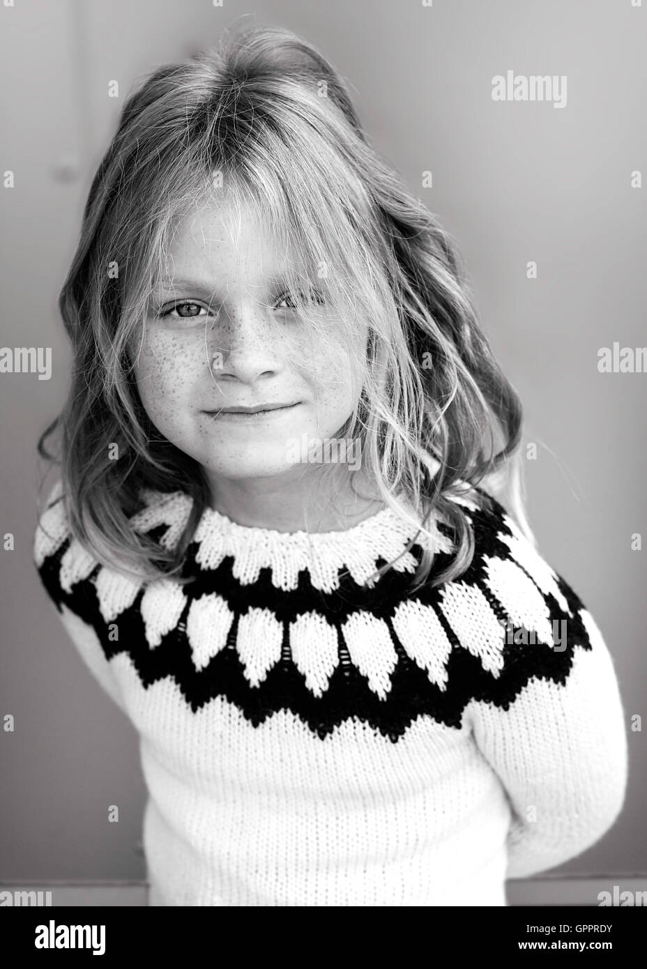 Young girl with a messy hair and wearing a sweater Stock Photo - Alamy