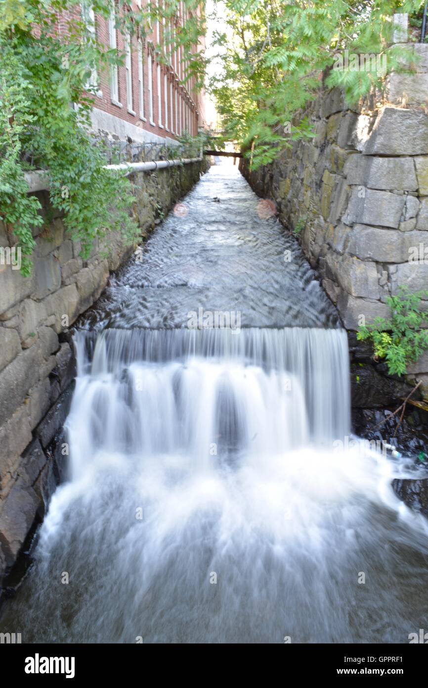 A long exposure of a Lowell Canal flowing into the Merrimack River at ...
