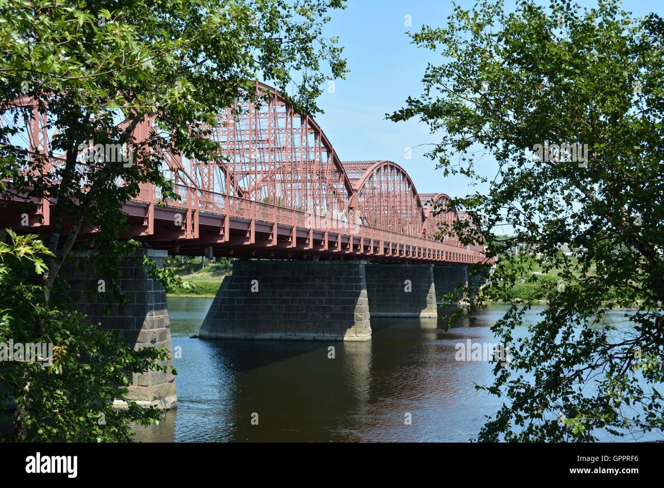 A bridge across the Merrimack River in Lowell Massachusetts, framed by ...