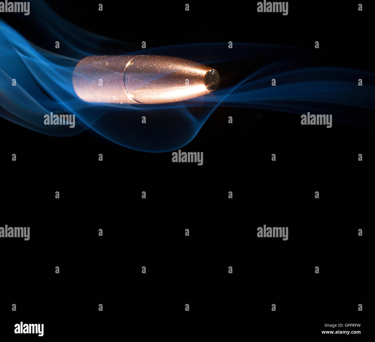 Copper plated bullet cruising in a cloud of smoke with a black ...