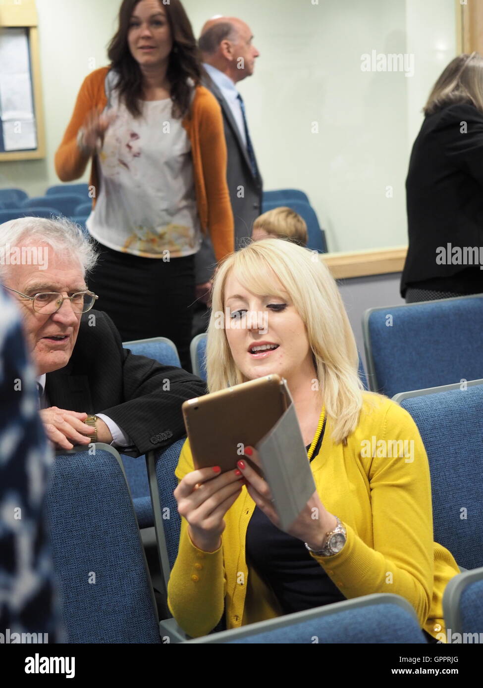 Woman shewing a tablet computer to an old man Stock Photo - Alamy