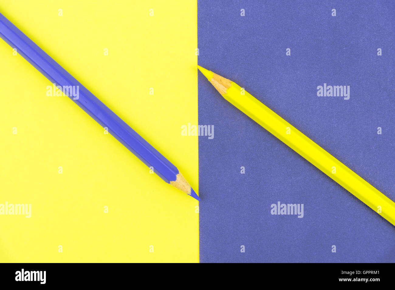 Yellow and Violet coloured pencils and paper, abstract contrast ...