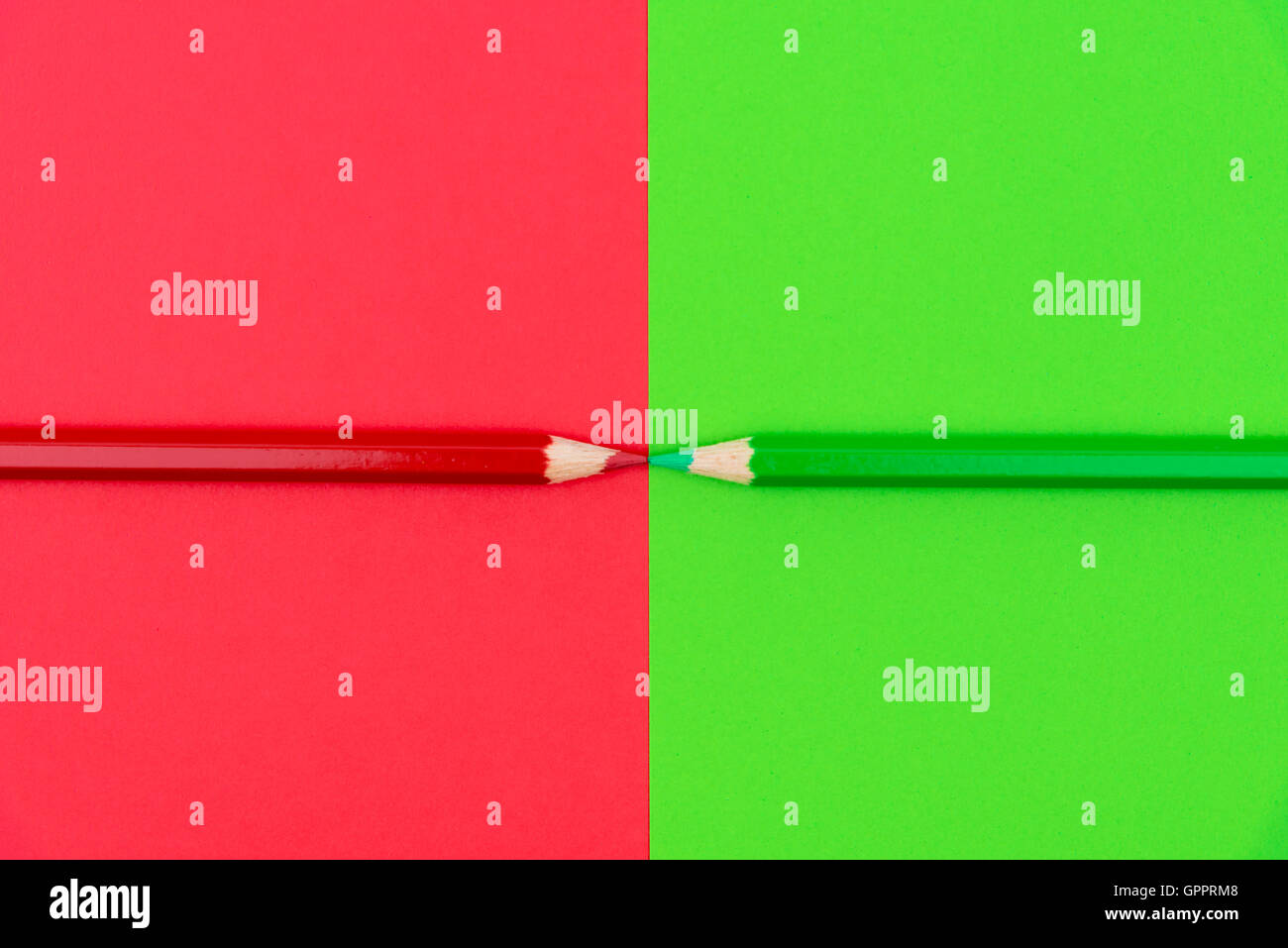 Green and Red coloured pencils and paper, abstract contrast conceptual ...