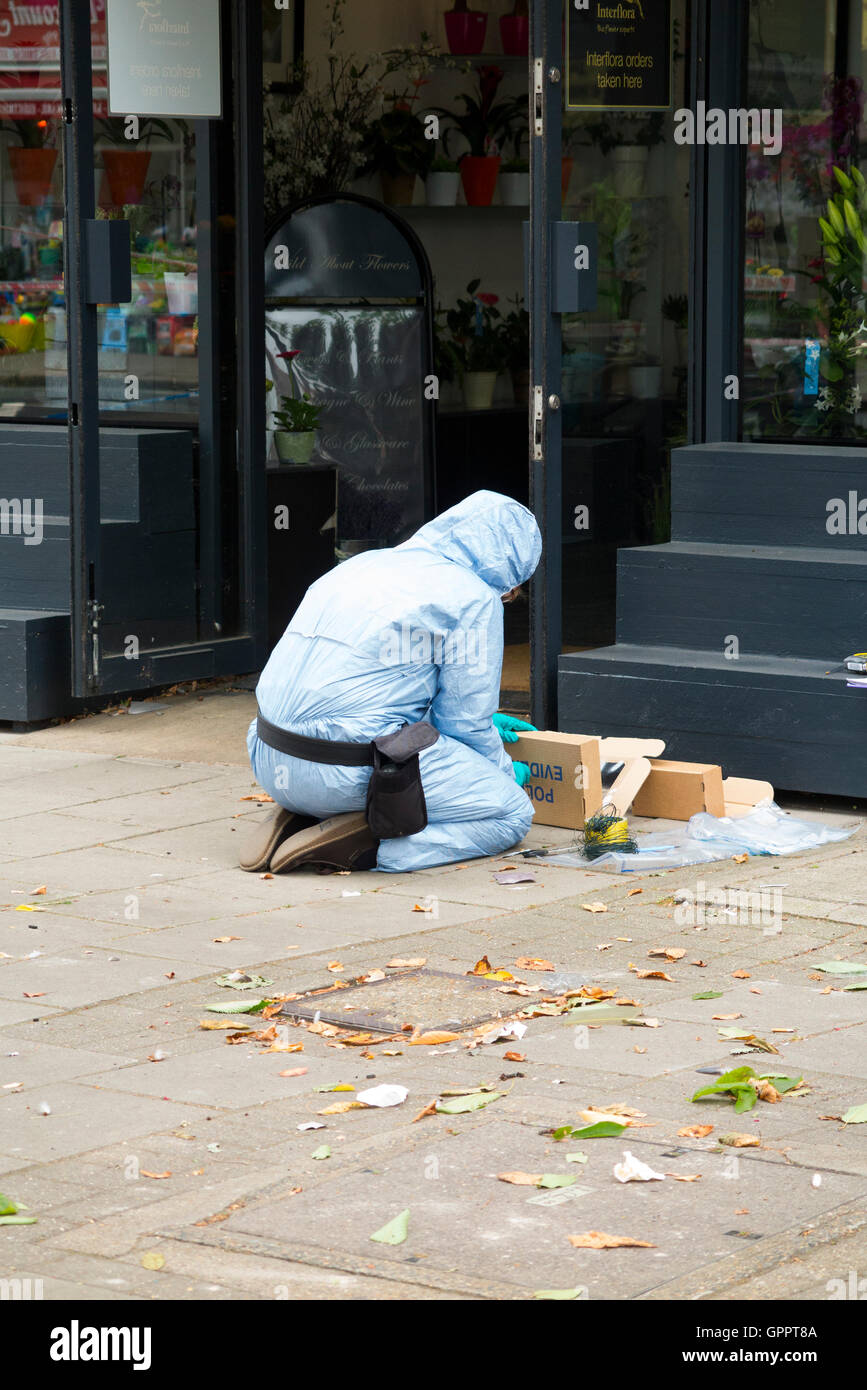 A scenes of crime officer / crimes officers working & gathering ...