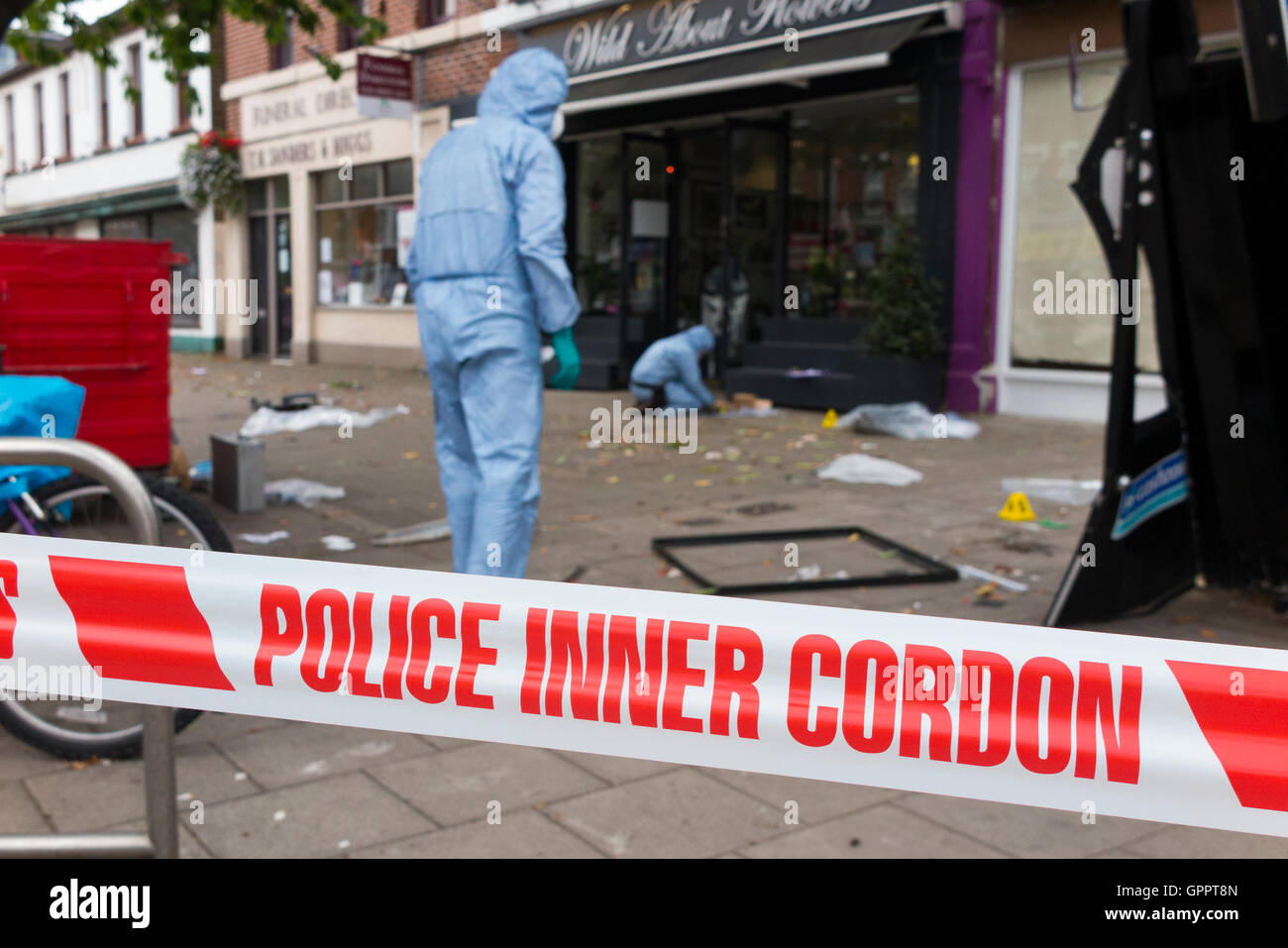Police inner cordon tape barrier and a scene of crime officer ...