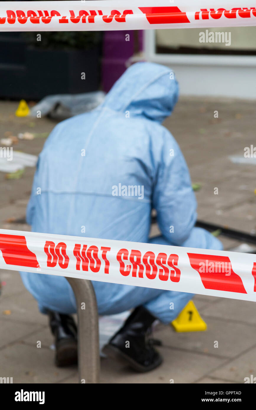 Police do not cross tape barrier & scene of crime officer / crimes ...