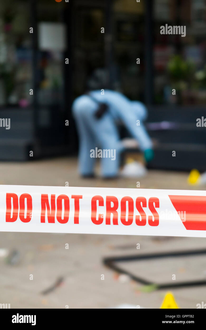 Police do not cross tape barrier & scene of crime officer / crimes ...