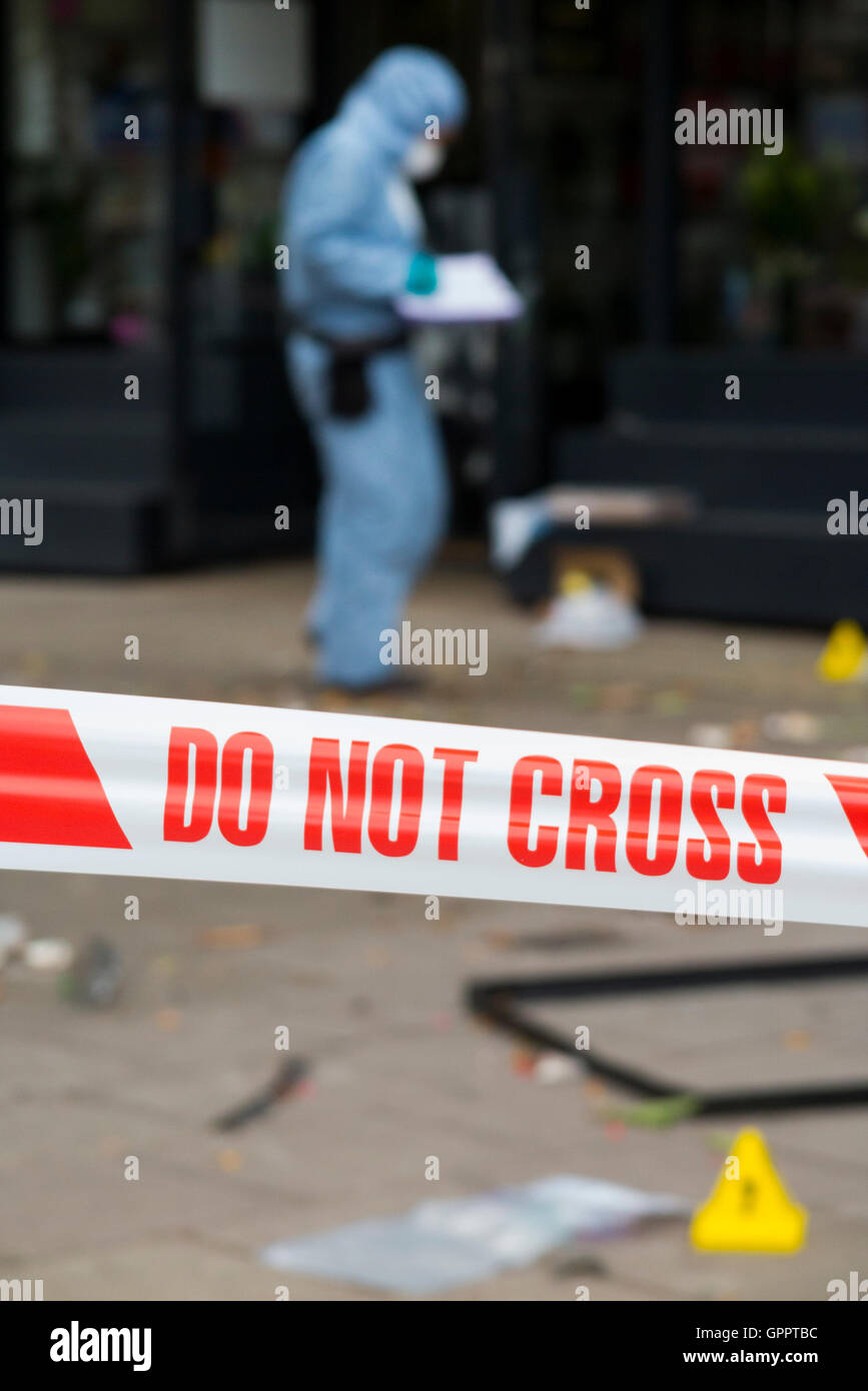 Police do not cross tape barrier & scene of crime officer / crimes ...