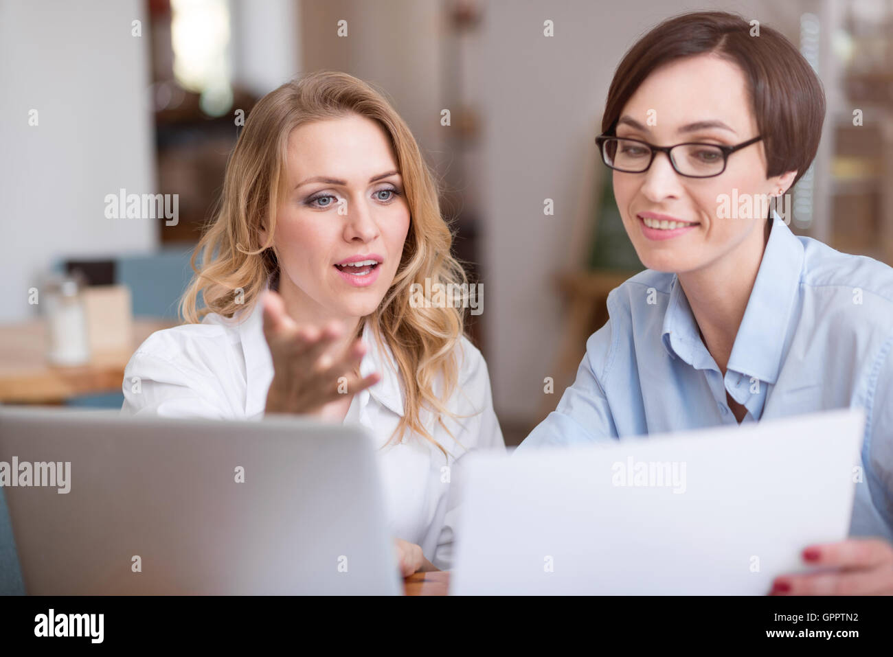Nice colleagues working together Stock Photo - Alamy