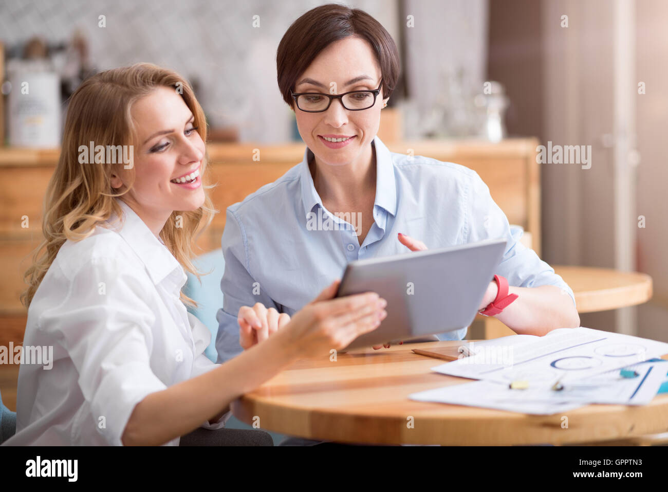 Pretty colleagues working together Stock Photo - Alamy