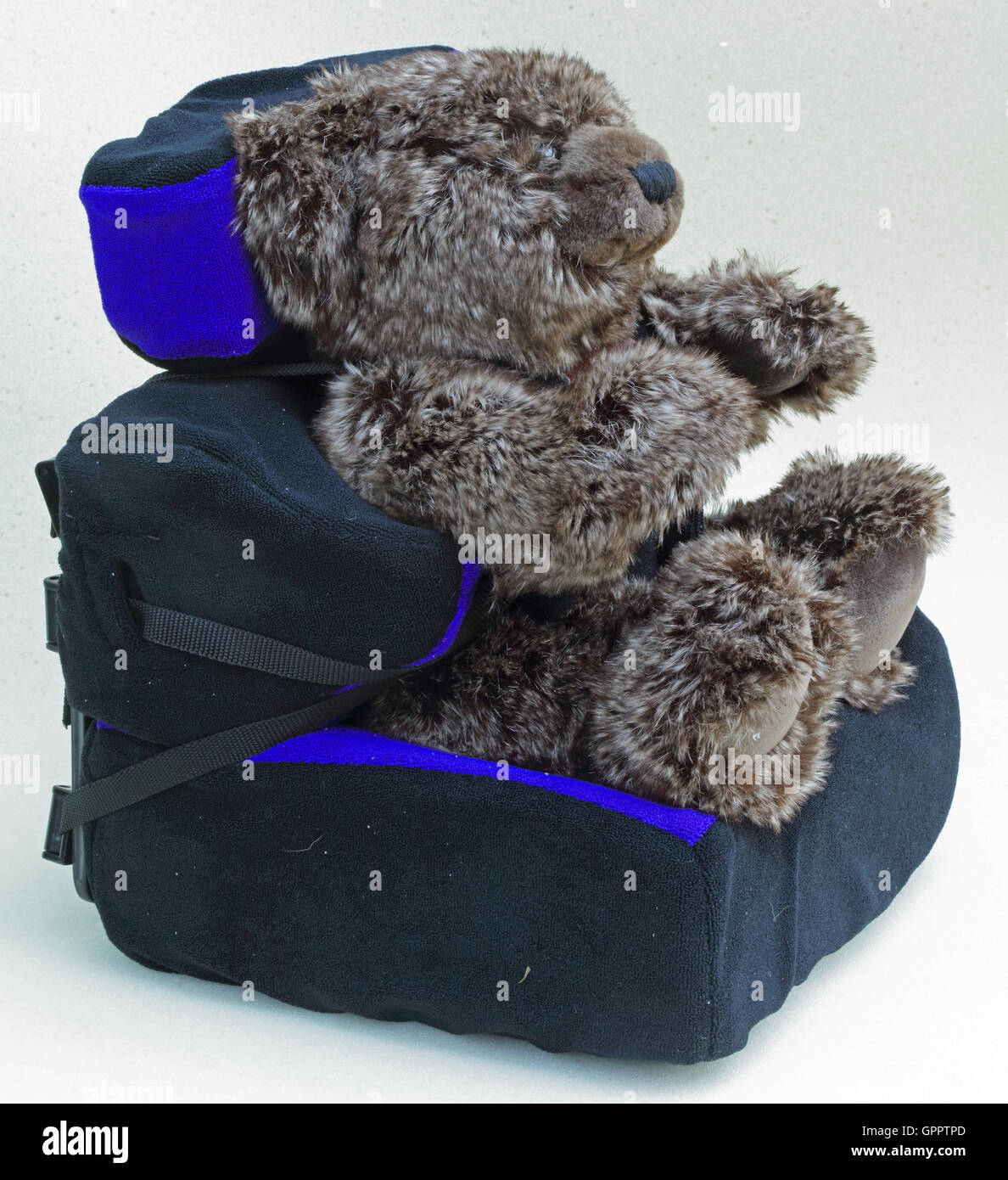 A cuddly Brown Teddy Bear sat and safely strapped and secured in a ...