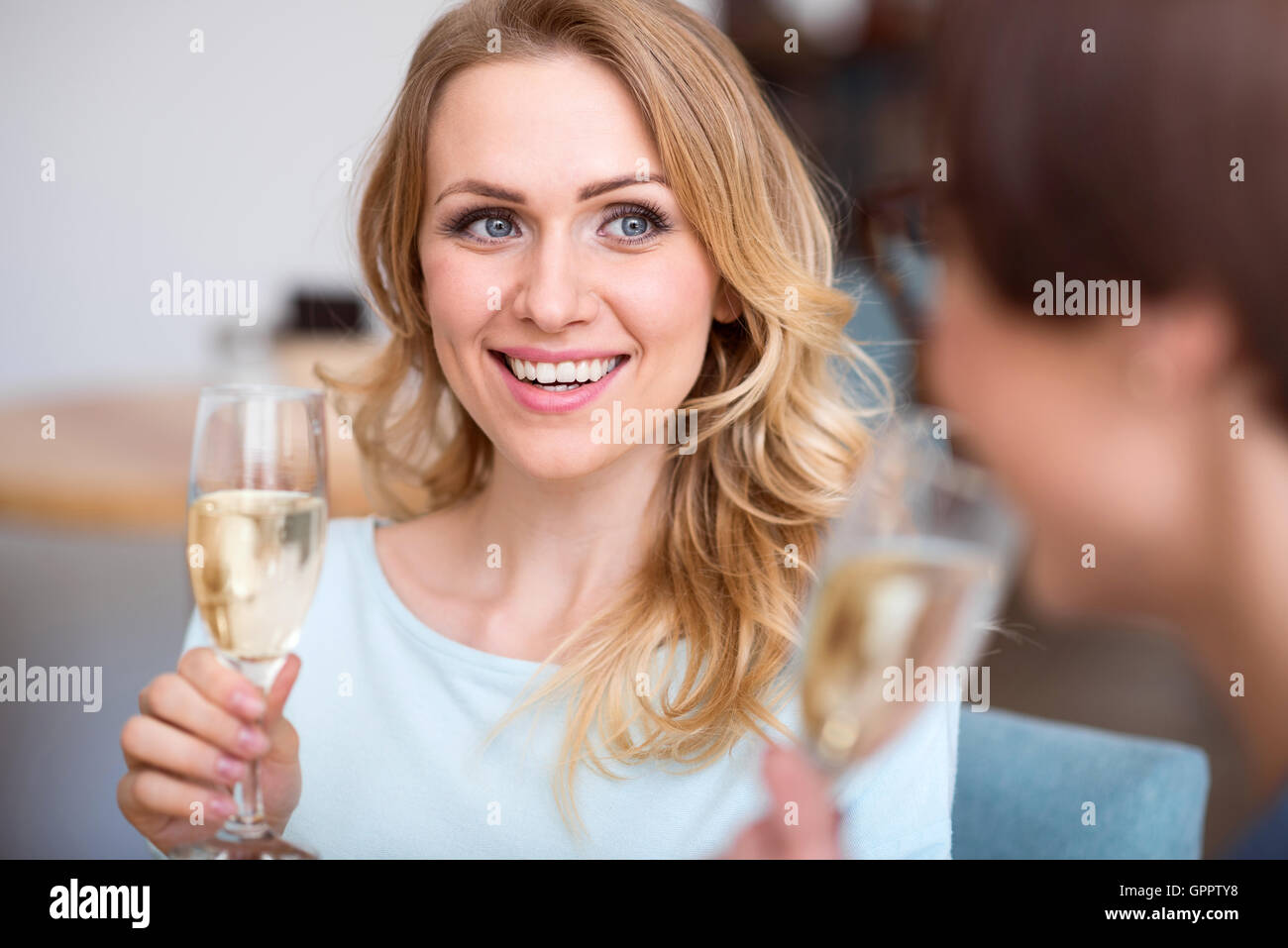 Pretty young woman drinking champagne Stock Photo - Alamy
