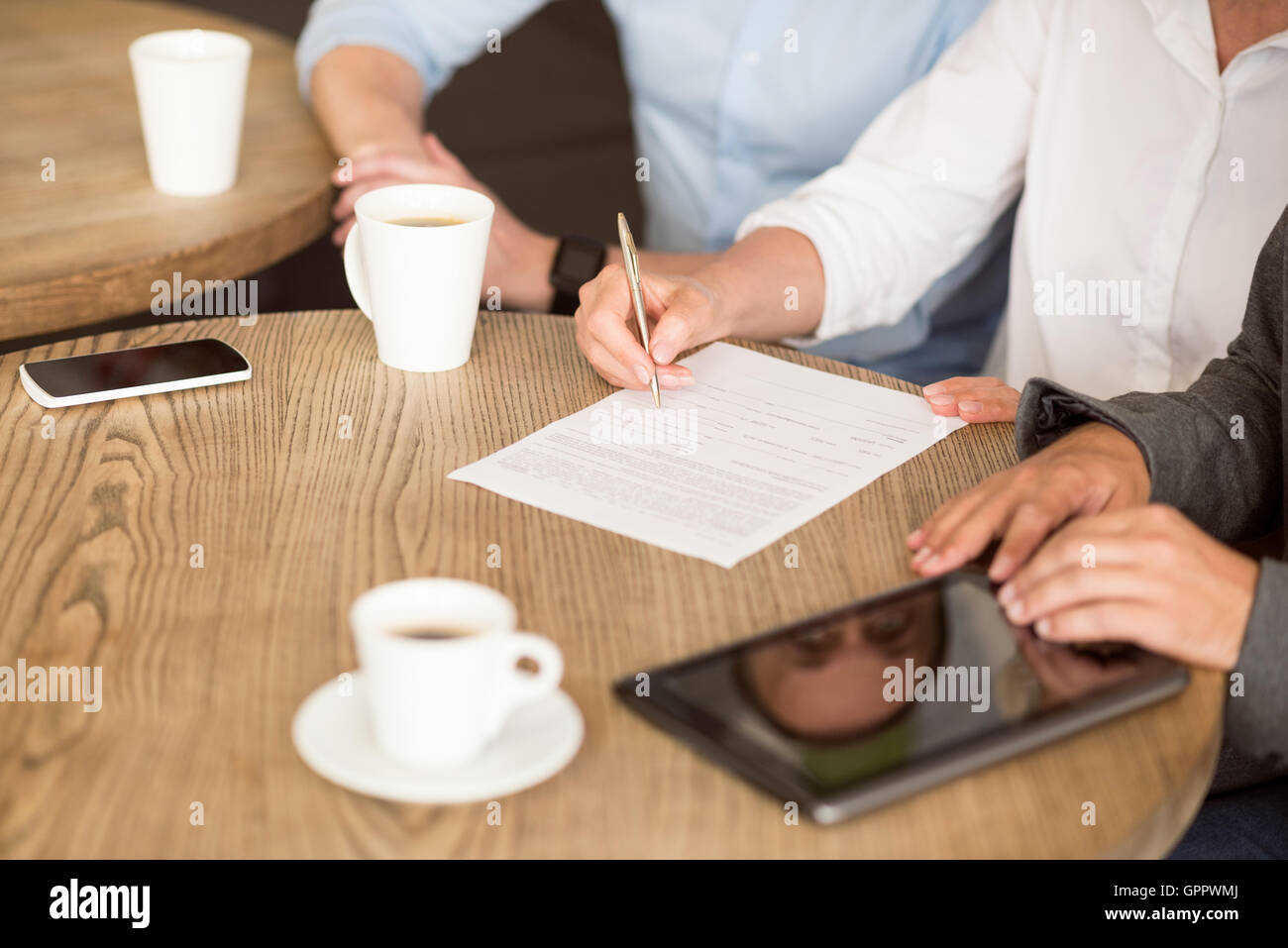 Woman signing papers hi-res stock photography and images - Alamy