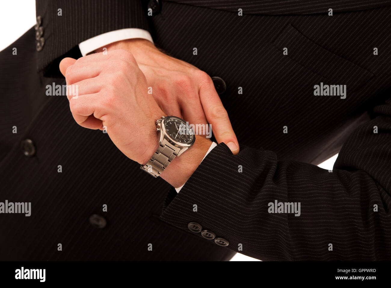 Successful businessman in formal suit checking time on wrist watch ...