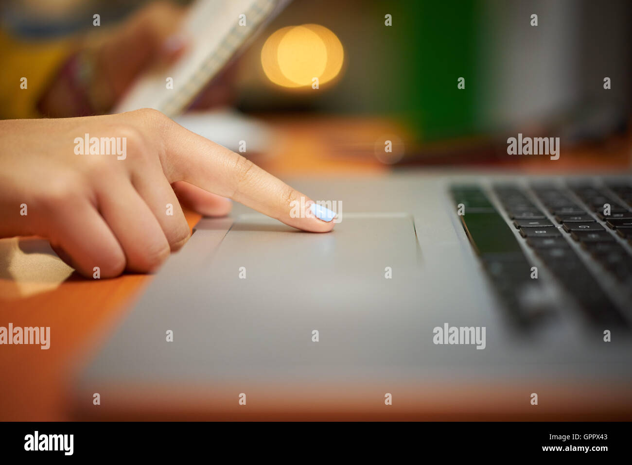 Young woman clicking on trackpad of laptop computer. Female student ...