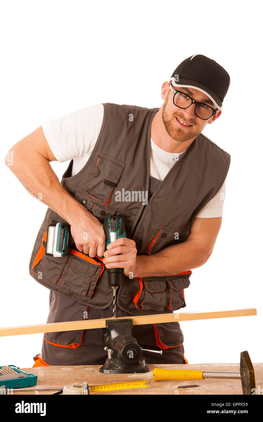 young carpenter drilling a hole in a wooden slat isolated over white ...