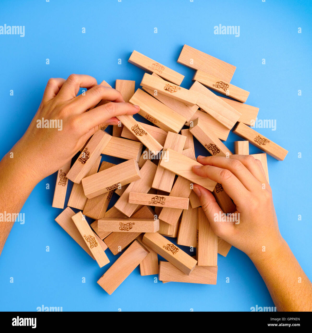 Tambov, Russian Federation - March 03, 2016 Woman hands taking Jenga ...